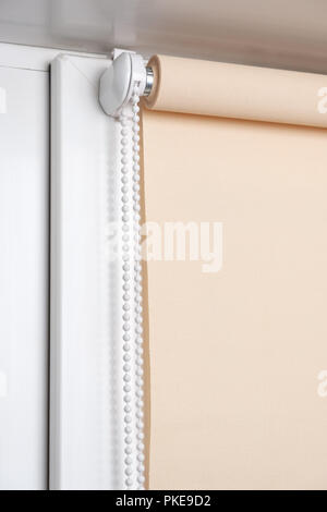 Beige blackout roller blind on the white plastic window. Shutters on ...