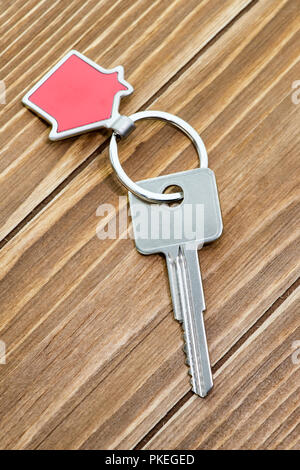 keychain with house symbol and keys on wooden background,Real estate ...