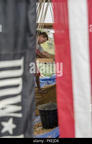 Petty Officer 2nd Class Wesley Pollard and his wife play with their dog ...