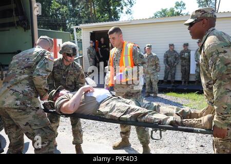 278th ACR soldiers lift a casualty patient into a field liter ambulance ...