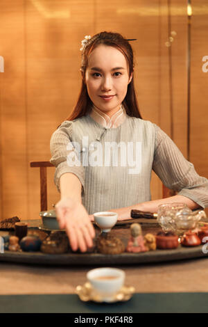 Young women show tea art Stock Photo - Alamy