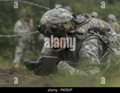 U.S. Army soldiers crawl under barbed wire during the team obstacle ...