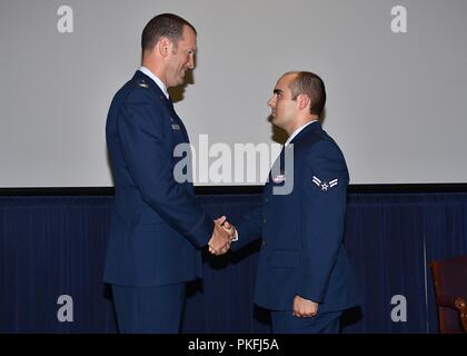 Col. Adam G. Wiggins, left, the commander of the 143d Operations Group ...