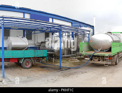 Unloading raw milk from trucks in dairy factory Stock Photo - Alamy