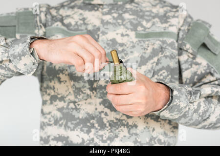 cropped shot of soldier holding grenade in hand isolated on grey Stock ...
