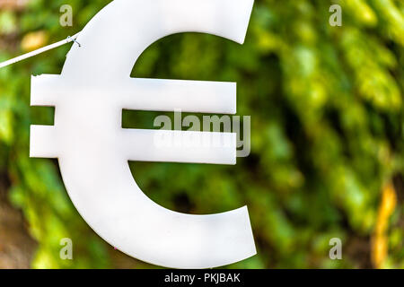 white euro sign hanging on bricks background Stock Photo - Alamy