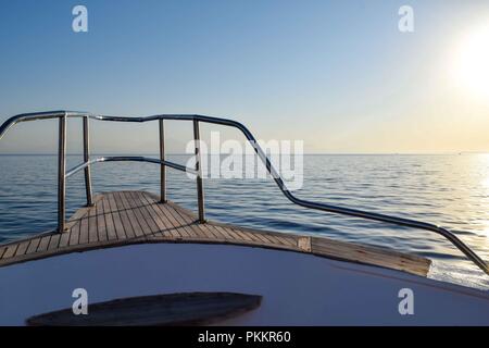 View from yacht over the ocean, horizon in background, blue sky, sunset ...