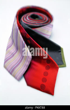 Blue rolled up tie isolated on white background Stock Photo - Alamy