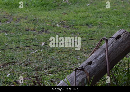 Old fence post falling down Stock Photo - Alamy