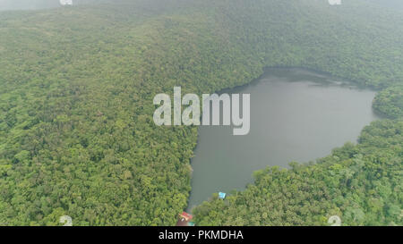 Aerial view of lake Bulusan in the mountains with green rain forest ...