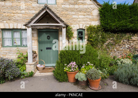 Front door and porch of typical Cotswolds cottage in village in ...