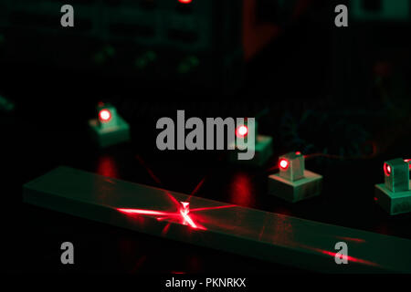 Experiment in the laboratory of Photonics with red lasers Stock Photo ...
