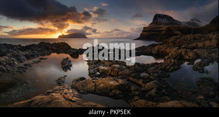 Panorama of Mulafossur waterfall and Mykines in cloudy sunset, Faroe ...