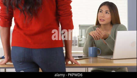 Asian manager assigning task to employee Stock Photo - Alamy