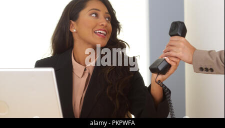 Mexican businesswoman answering phone call Stock Photo - Alamy