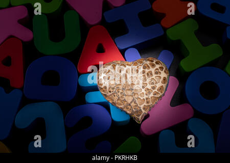 Heart shape and colorful Letters made of wood on sand Stock Photo - Alamy