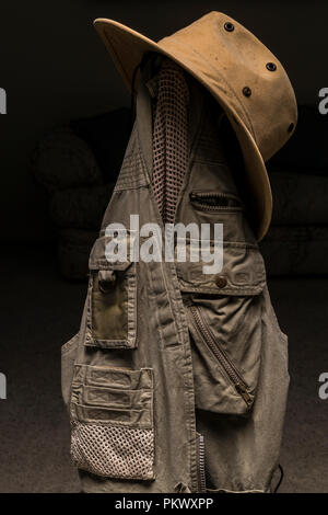 nostalgic hat and photo vest on light stand Stock Photo - Alamy