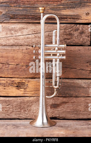 Aged trumpet on wooden background. Old trumpet with brassy mouthpiece ...