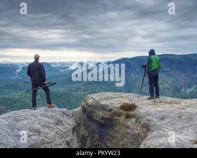 Outdoor shot of talented hobby photographers taking pictures in rocks ...