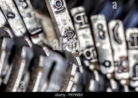 Metal element of the writing of a typewriter, highlighting the dollar ...