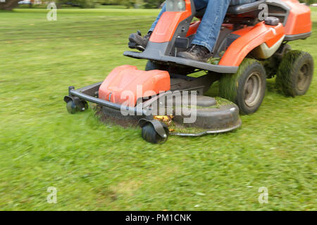 lawn mower tractor working in the town park Stock Photo - Alamy