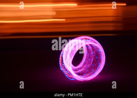 abstract pan of hoola hoop rolling night long exposure Stock Photo - Alamy