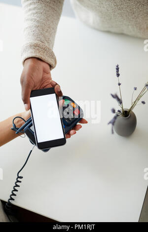 A human hand holding a swipe machine Stock Photo - Alamy