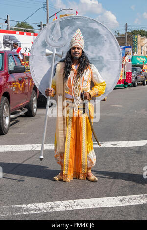 A participant dressed in a costume poses for photos during the ...