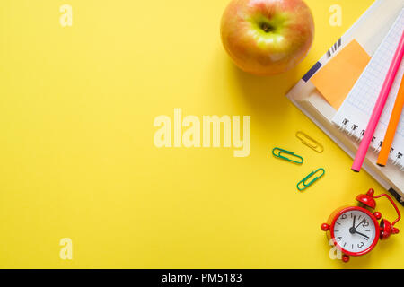 Stationery, Apple and cookies on the yellow table with copy space ...