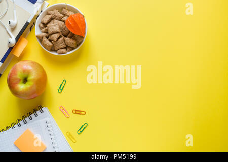 Stationery, Apple and cookies on the yellow table with copy space ...