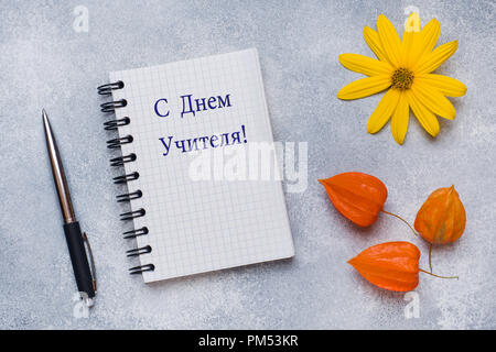 Inscription Teacher's Day. Autumn flowers and Notepad for text on ...