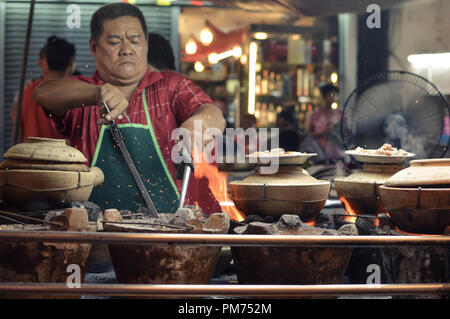 clay pot cooking at a street vendor stall in Kuala Lumpur, Malaysia ...