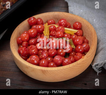 Pickled red cherry tomatoes in the bowl Stock Photo - Alamy