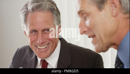 Two senior businessmen are laughing and talking about the plans, high ...