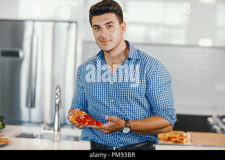 Young man holding pizza isolated on white Stock Photo - Alamy