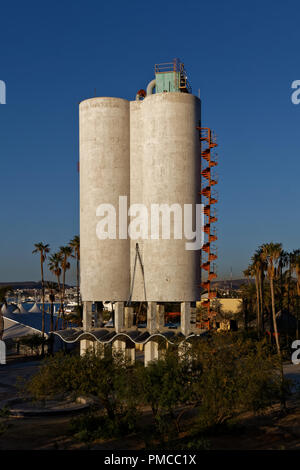White metal storage building surrounded by debris beside concrete ...