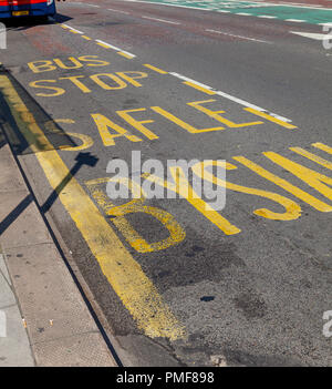 Bilingual Welsh English road markings at bus stop Cardiff Wales UK ...