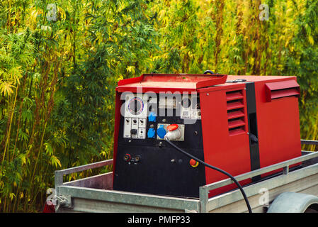 Electric power aggregate generator in industrial hemp field Stock Photo ...