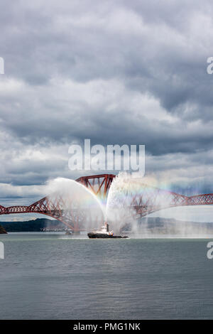 Tug boat using water cannon at Forth Bridge Stock Photo - Alamy