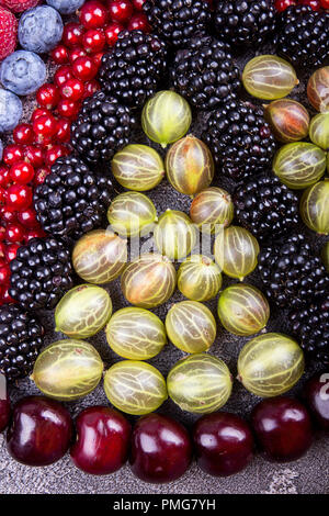 Rows of assorted fruits and berries: sweet cherry, bluberries ...