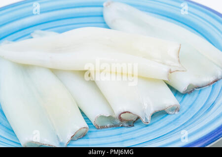 Raw squid rings for cooking in the plate Stock Photo - Alamy