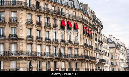 A Haussmann style building with black wrought iron railings on the ...