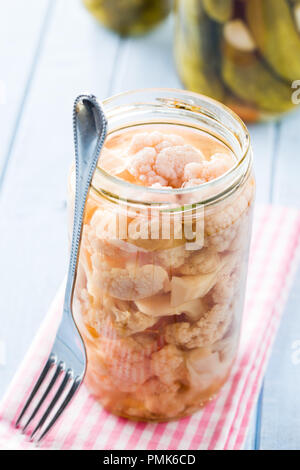 Pickled vegetables in a jar on a wooden table Stock Photo - Alamy