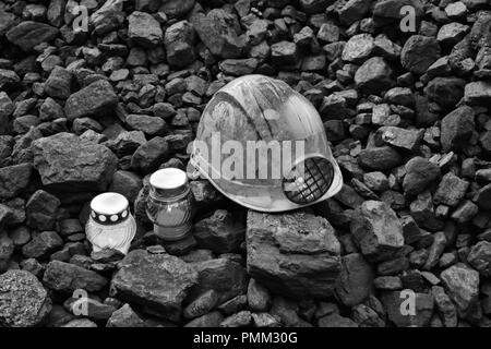 Vigil light, candle with mining helmet on cheap of coal after the fatal ...