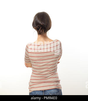 Woman in white blouse and jeans sitting on a floor at home and looking ...