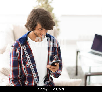 modern guy looking at screen smartphone at home Stock Photo - Alamy