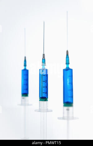Syringes with blue liquid Stock Photo - Alamy