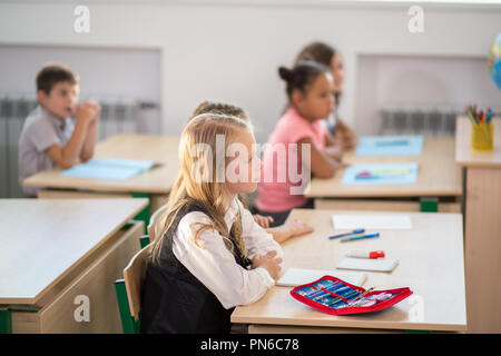 school children participating actively in class. Education, learning ...