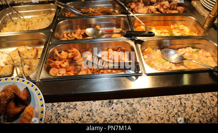 many fried foods in the trays of a self service all-you-can-eat ...