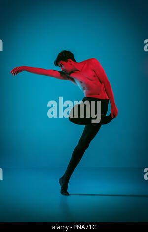 The male athletic ballet dancer performing dance isolated on white ...